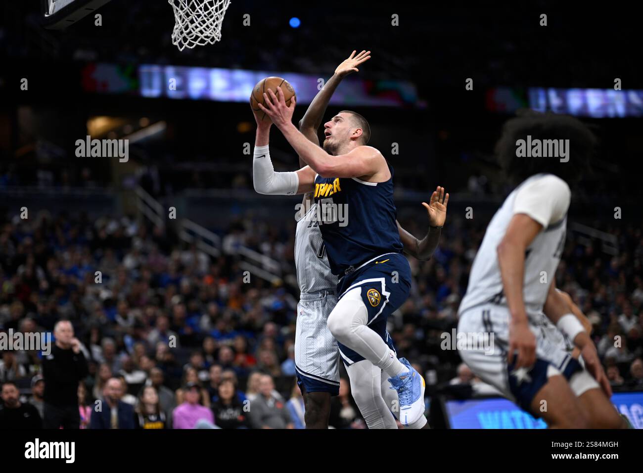Denver Nuggets center Nikola Jokic (15) goes up to shoot in front of ...