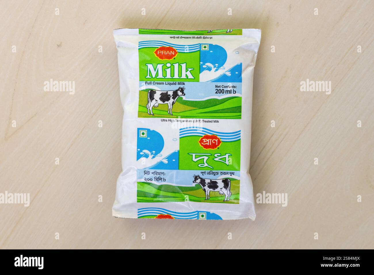 A Full Cream Liquid Milk packet on a wooden backdrop. This Ultra High ...