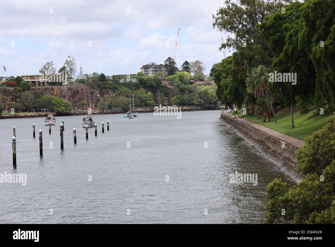 boats on a river with fortified banks and high rocky walls along the ...