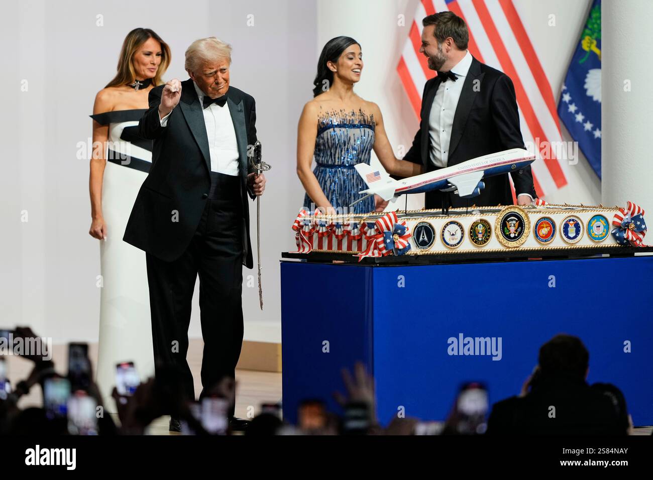 President Donald Trump, second from left, holds a sabre after using it ...