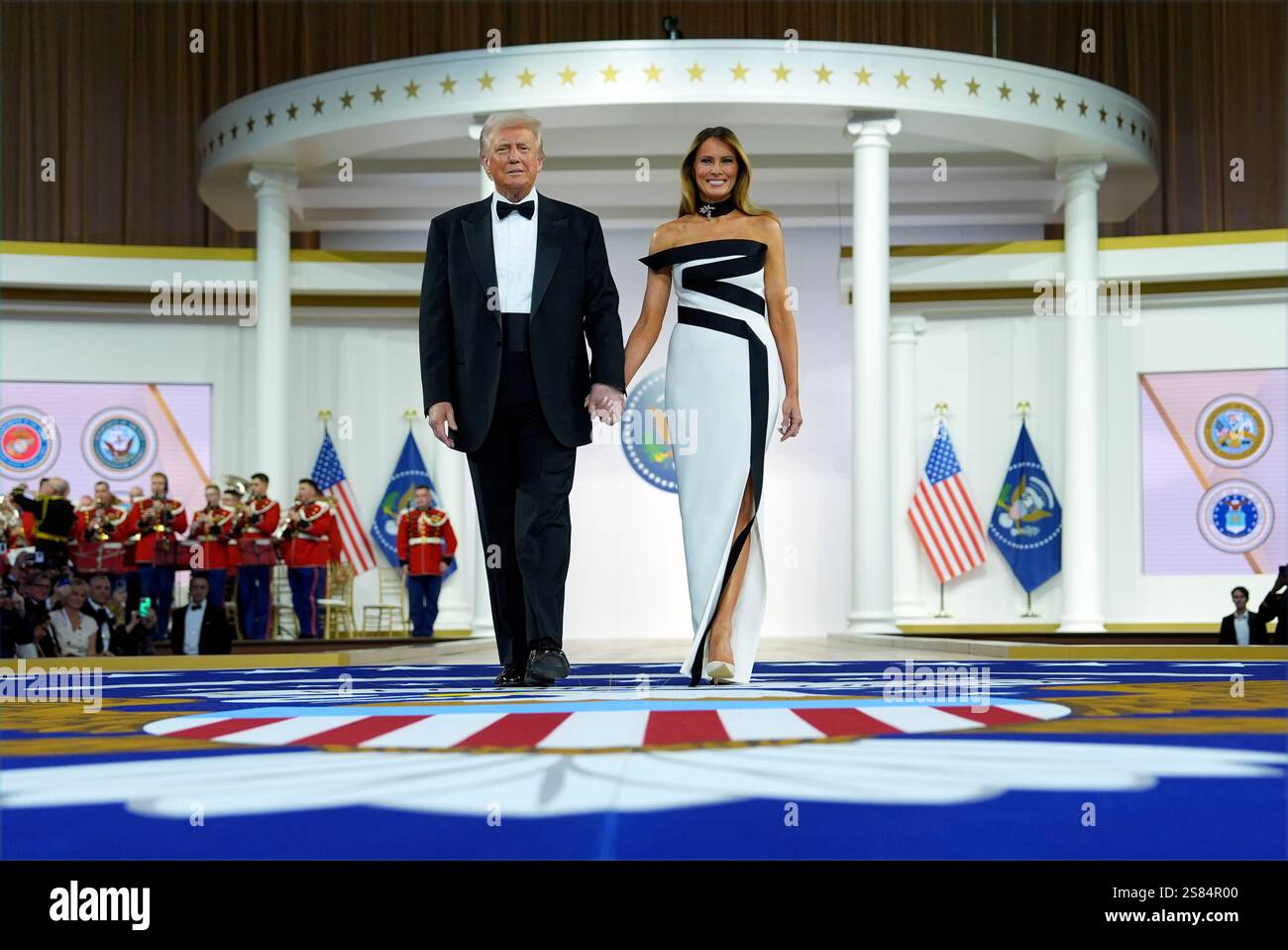 President Donald Trump and first lady Melania Trump walk to dance at the Commander in Chief Ball ...