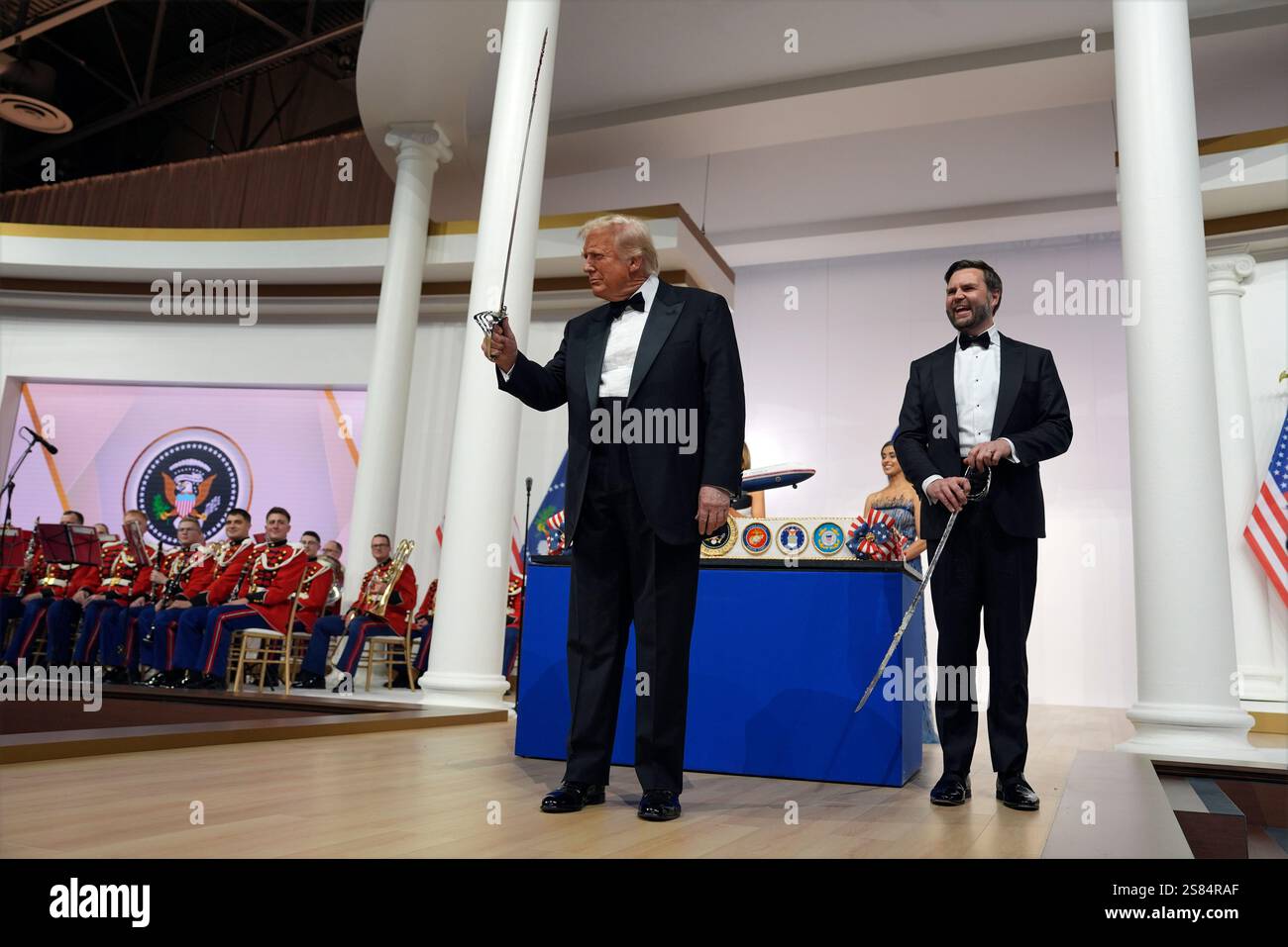 President Donald Trump and hold a sabre before cutting a cake at the ...