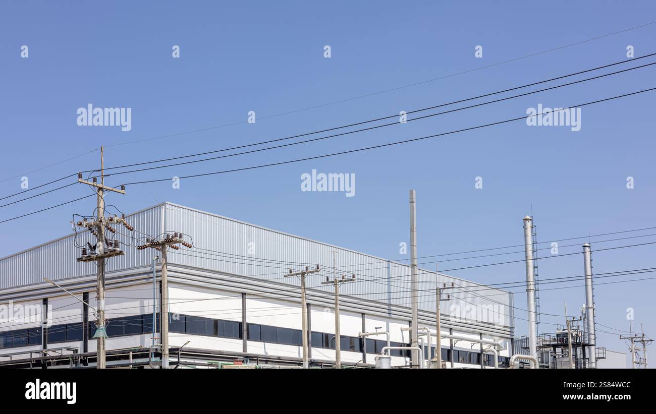 Side of industrial factory building with ventilation ducts and pipes ...