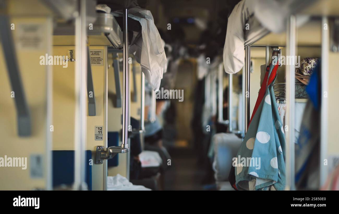 Clothes and bags hanging in a train wagon during a long trip ...