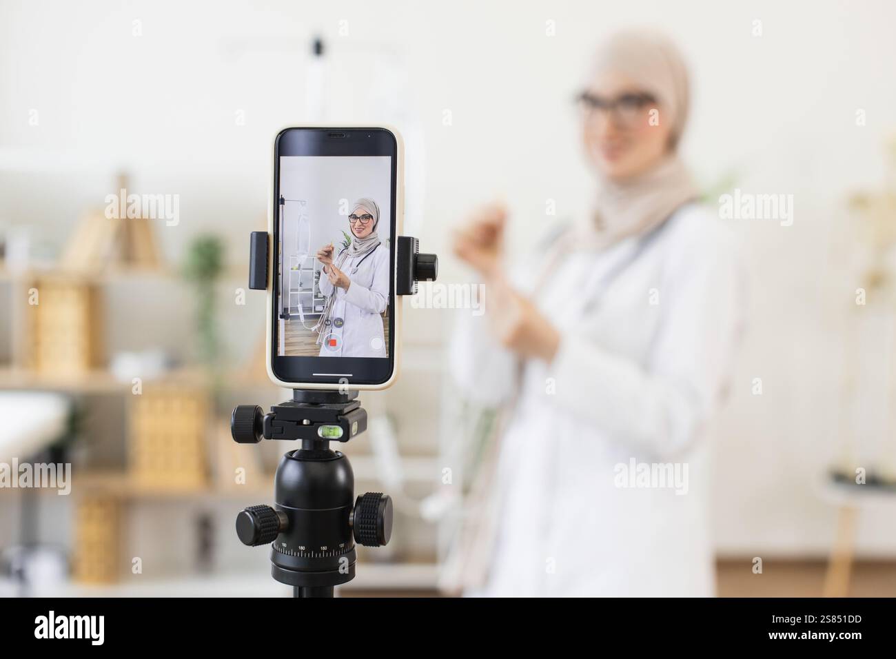 Middle-eastern adult female doctor recording video lesson on medical ...
