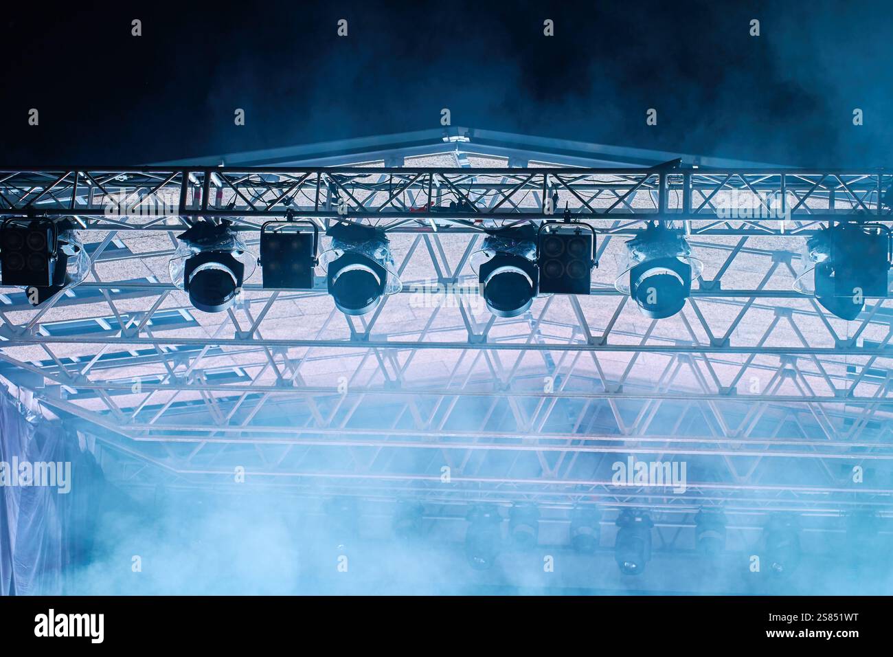Close-up view of professional stage lighting mounted on metal truss ...