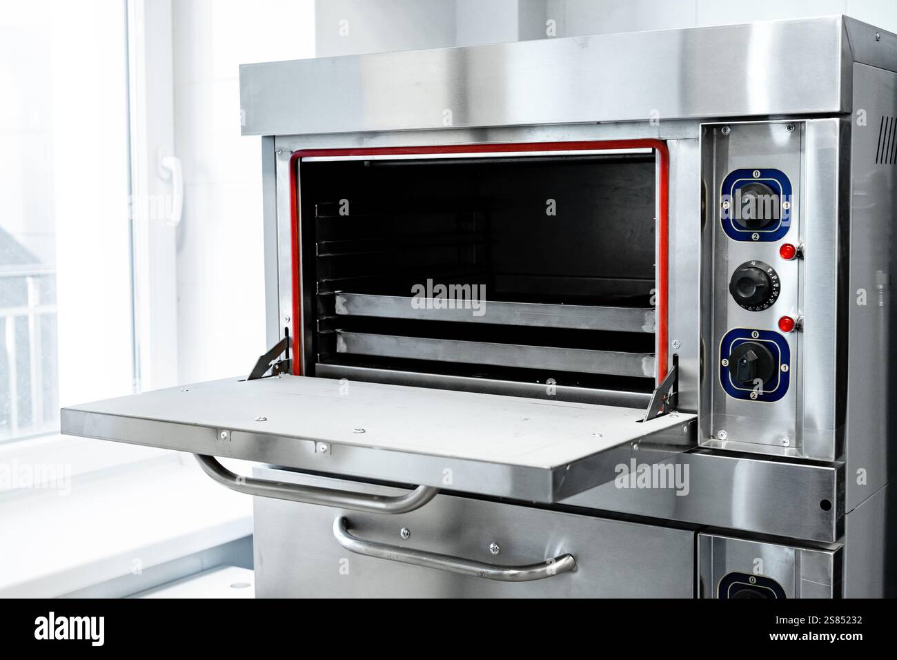 Industrial baking oven with open door and visible interior racks in a ...