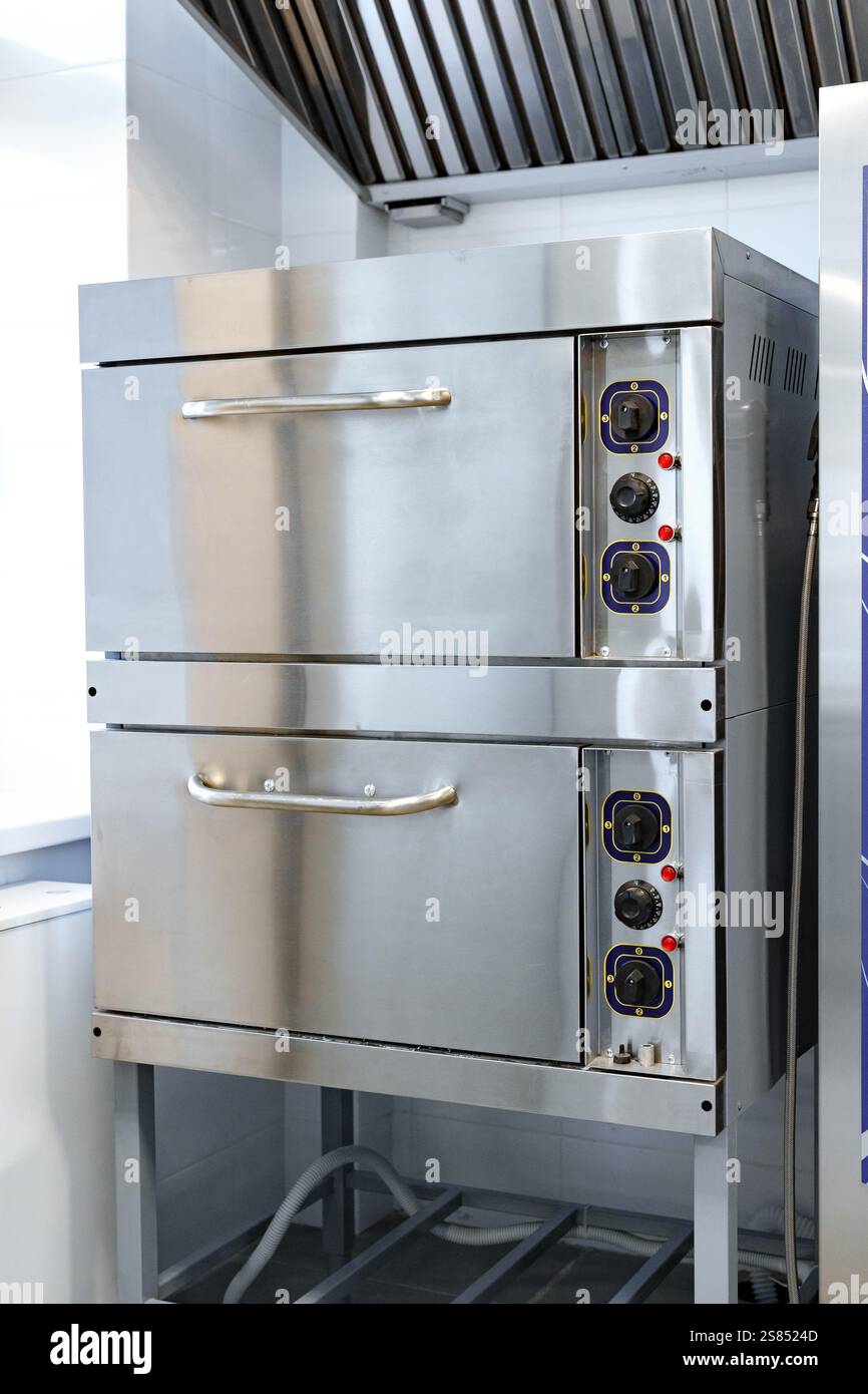 Stainless steel commercial oven setup in a modern kitchen with ...