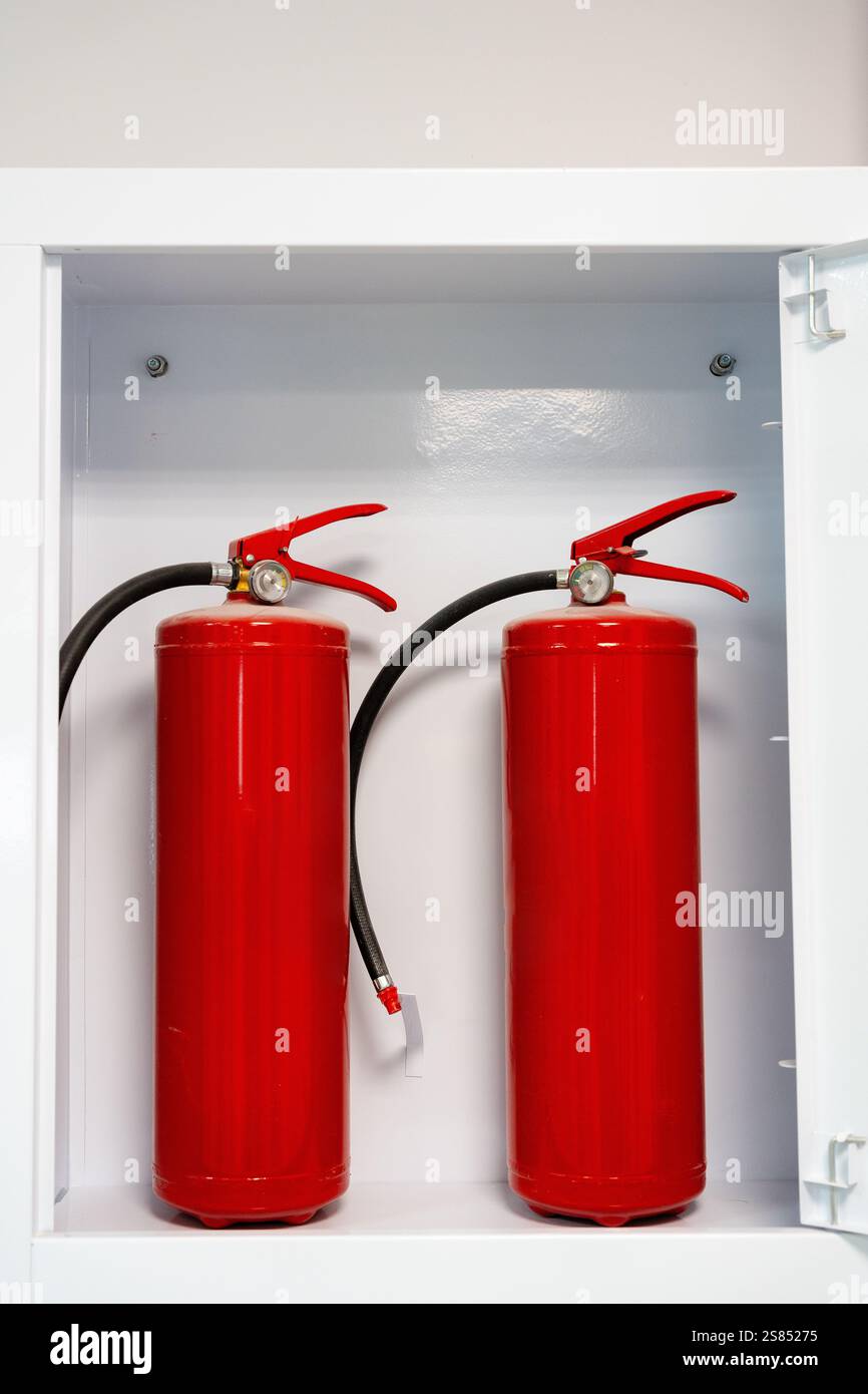 Fire safety equipment displayed in a storage cabinet for emergency ...