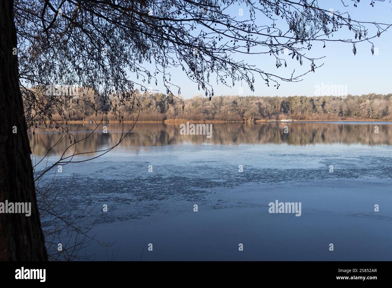 A picturesque winter scene at Straussee, with a partially frozen lake ...