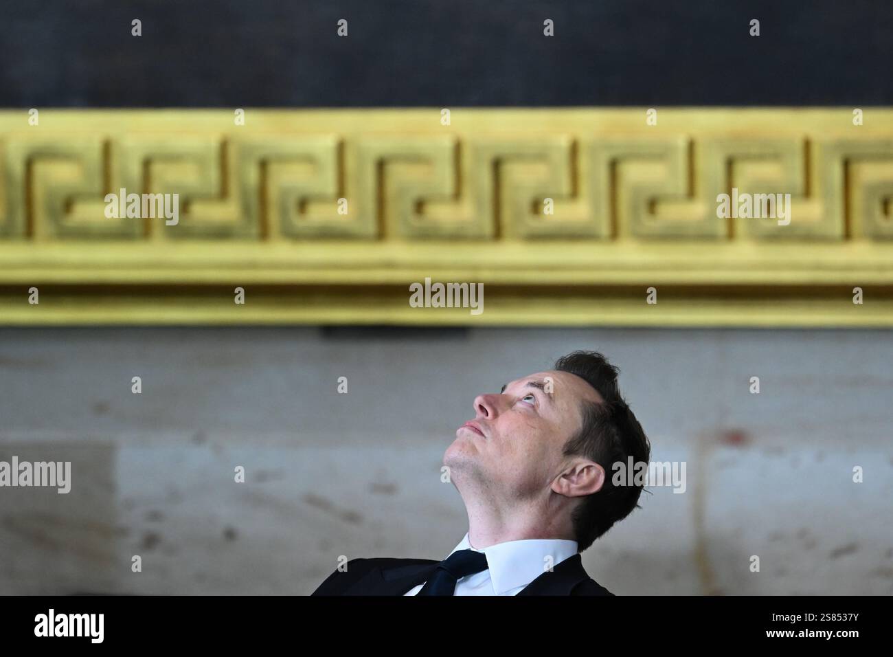 Tesla and SpaceX CEO Elon Musk looks upward as he sits in his seat ...