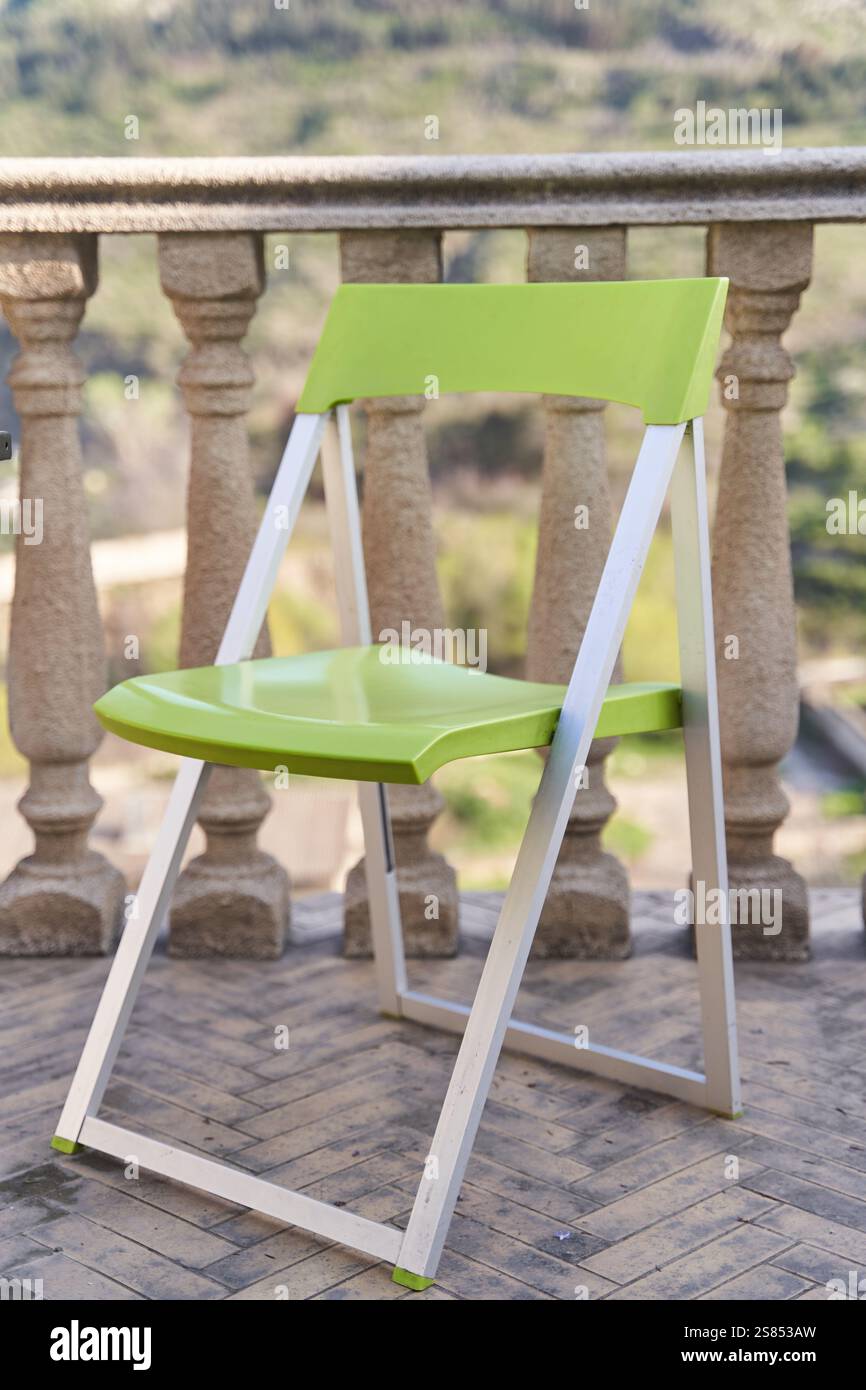 Green folding chair on the terrace with balustrades Stock Photo - Alamy