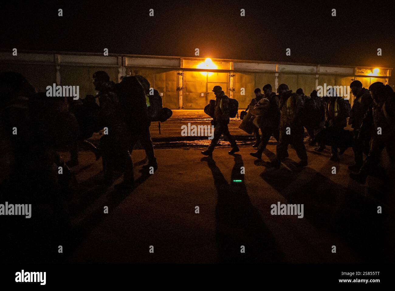 British military vehicle drivers leave their vehicles for a briefing ...