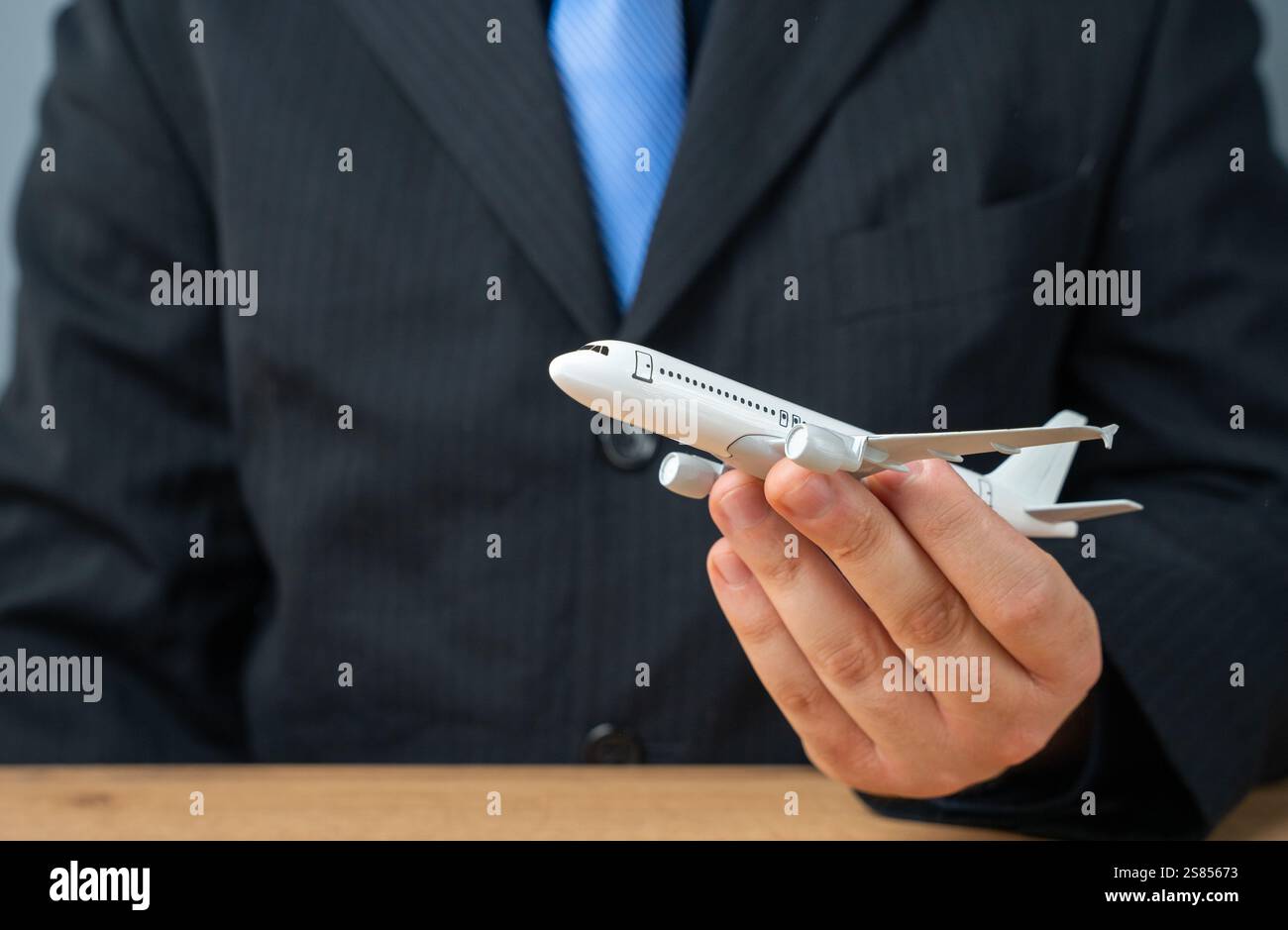 An airliner taking off in the hand of a businessman or official ...