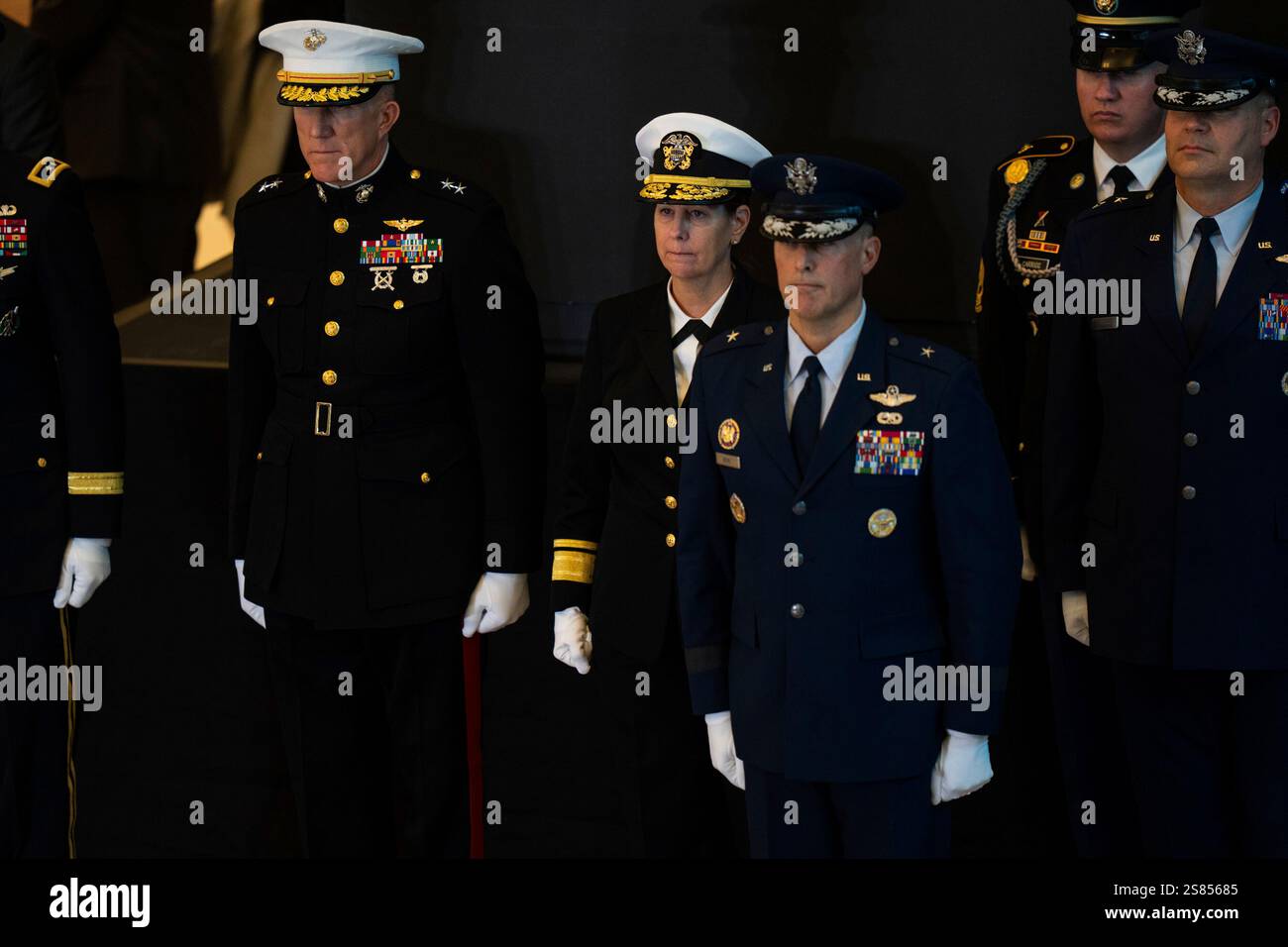Members of the military stand as President Donald Trump reviews the ...