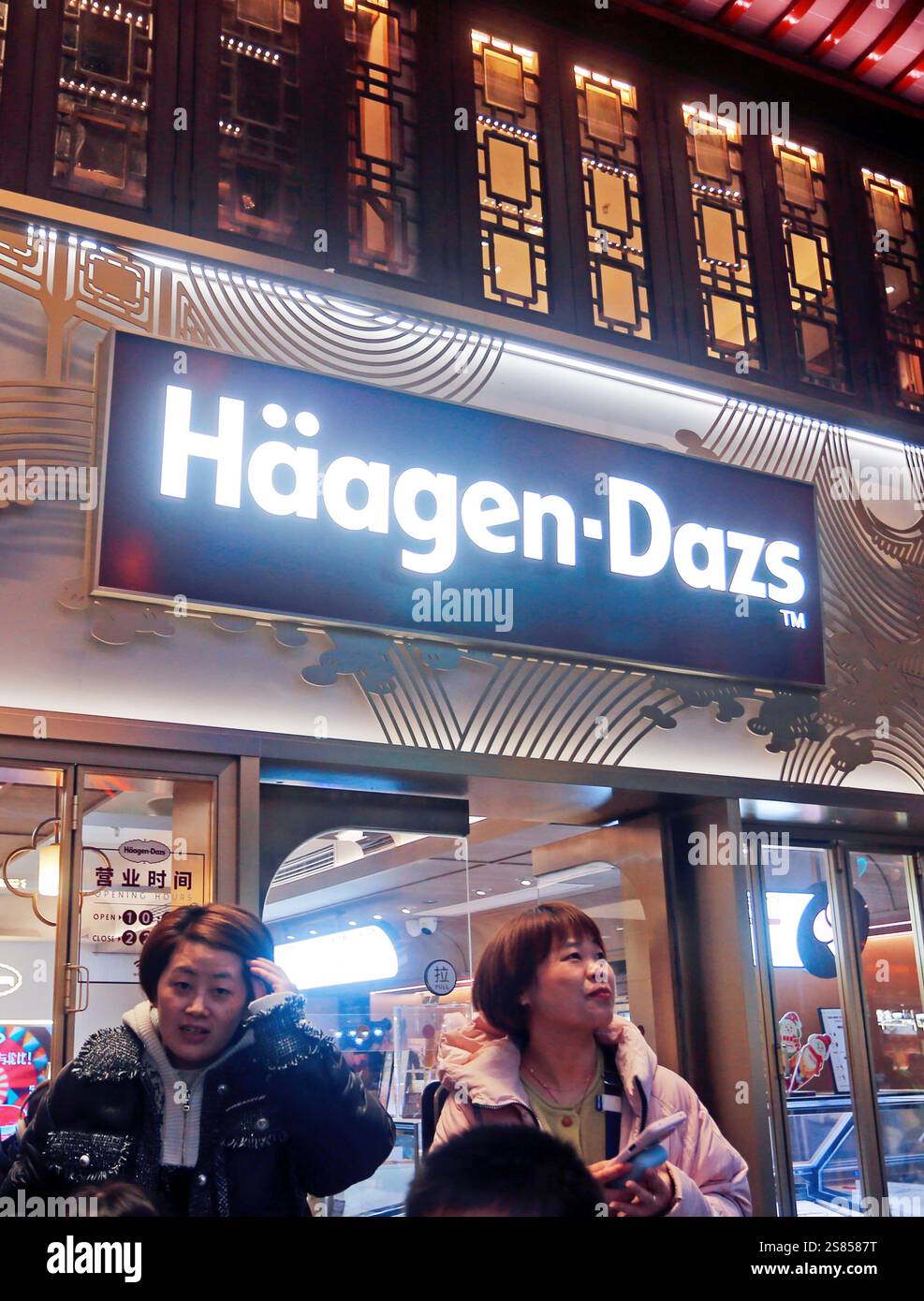 Customers spend money at a Haagen-Dazs ice cream store at Yuyuan Mall in Shanghai, China ...