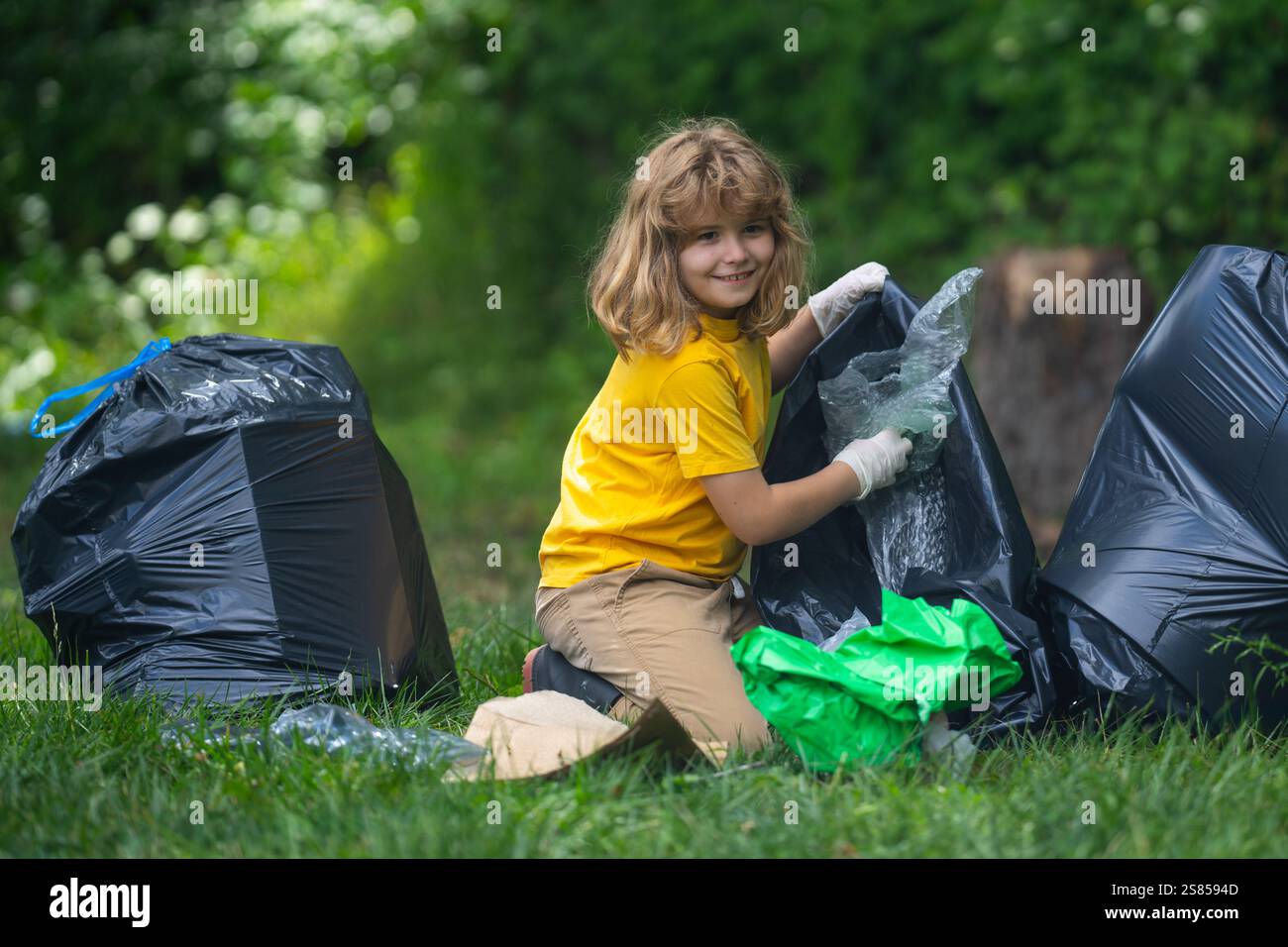 Child collecting trash outside. Ecology concept. Environmental ...