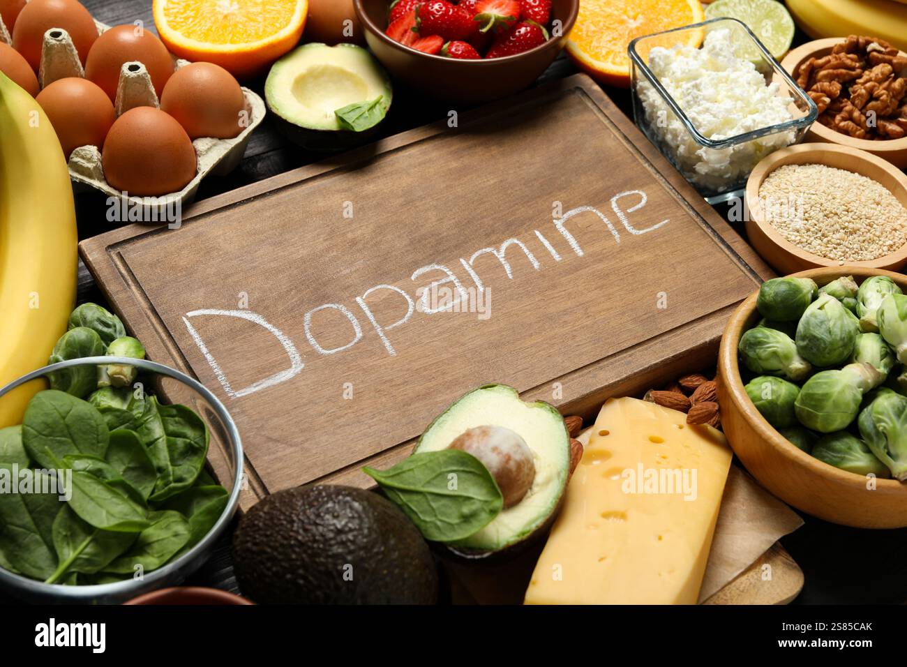 Wooden board with word Dopamine and different products as background ...