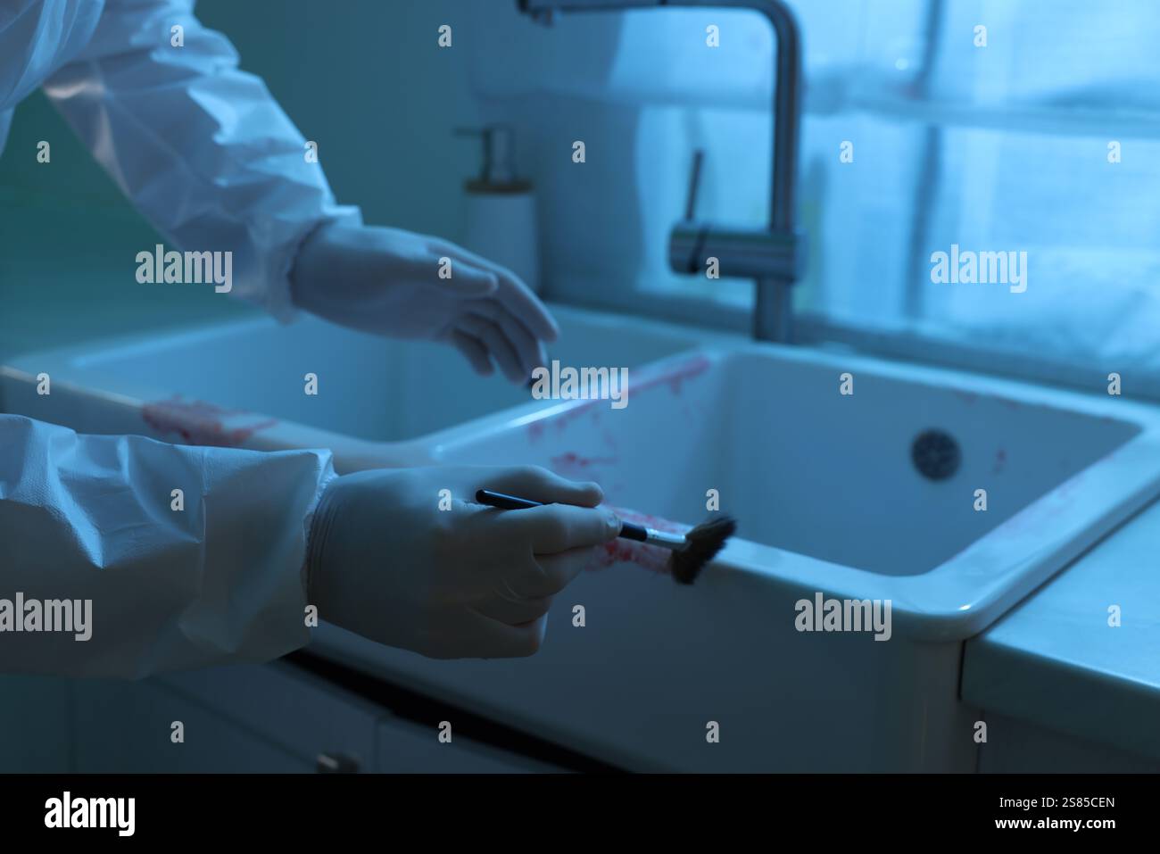 Forensic expert taking fingerprints from sink with brush at crime scene indoors, closeup Stock ...