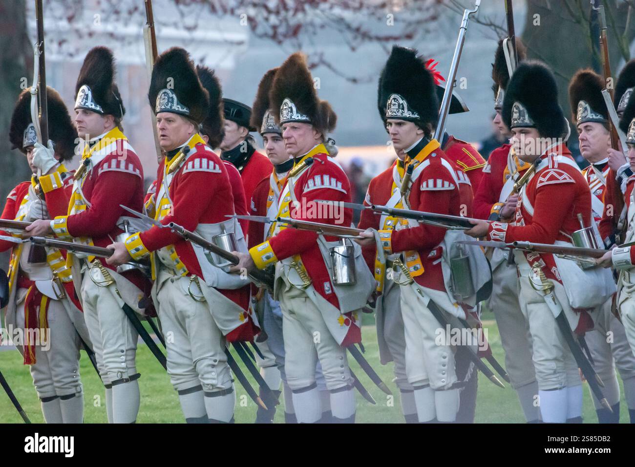 British troops at the 1775 Battle of Lexington reenactment in morning fog and musket smoke ...
