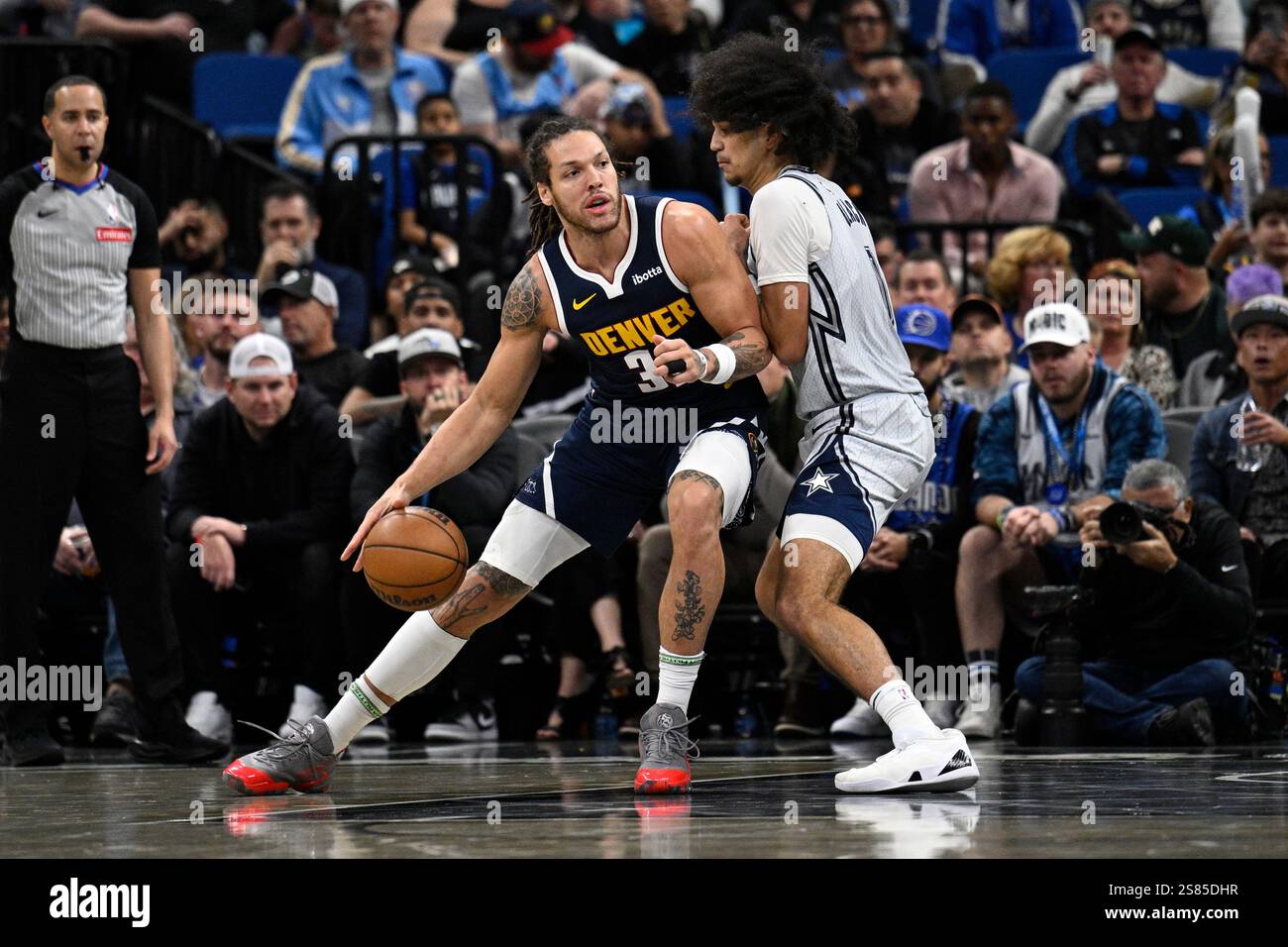 Denver Nuggets forward Aaron Gordon (32) is defended by Orlando Magic ...