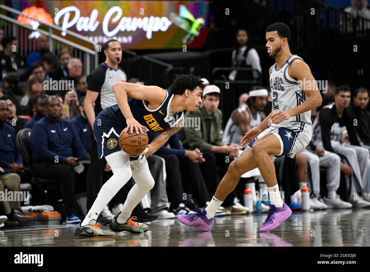 Denver Nuggets guard Julian Strawther, left, is defended by Orlando ...