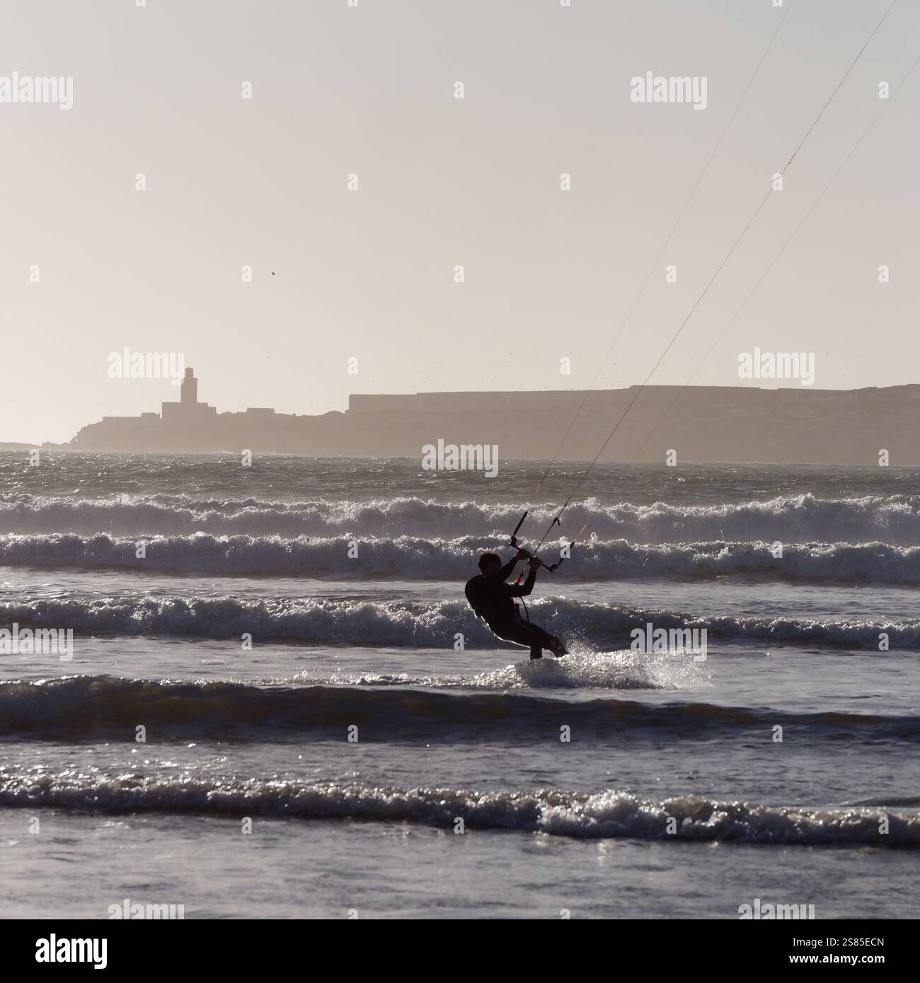 Kite Surfer at sea with an Island behind on the horizon in the town of ...