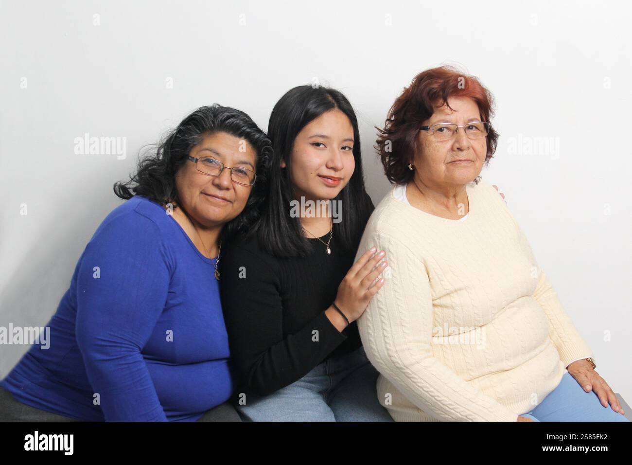 Three generations of brown Latina women, grandmother, mom and daughter ...