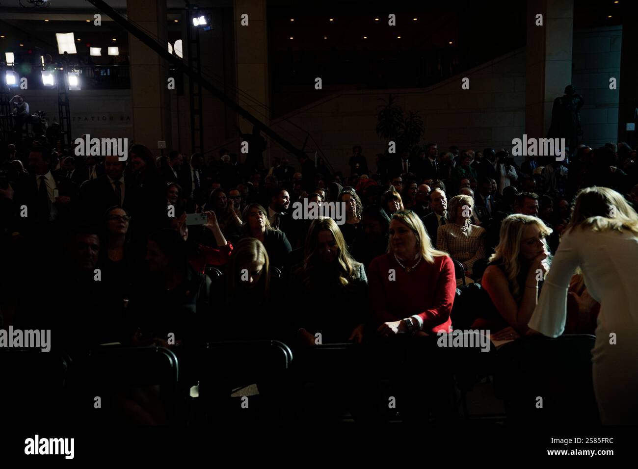 Attendees are seen in an overflow room for President-elect Donald Trump ...
