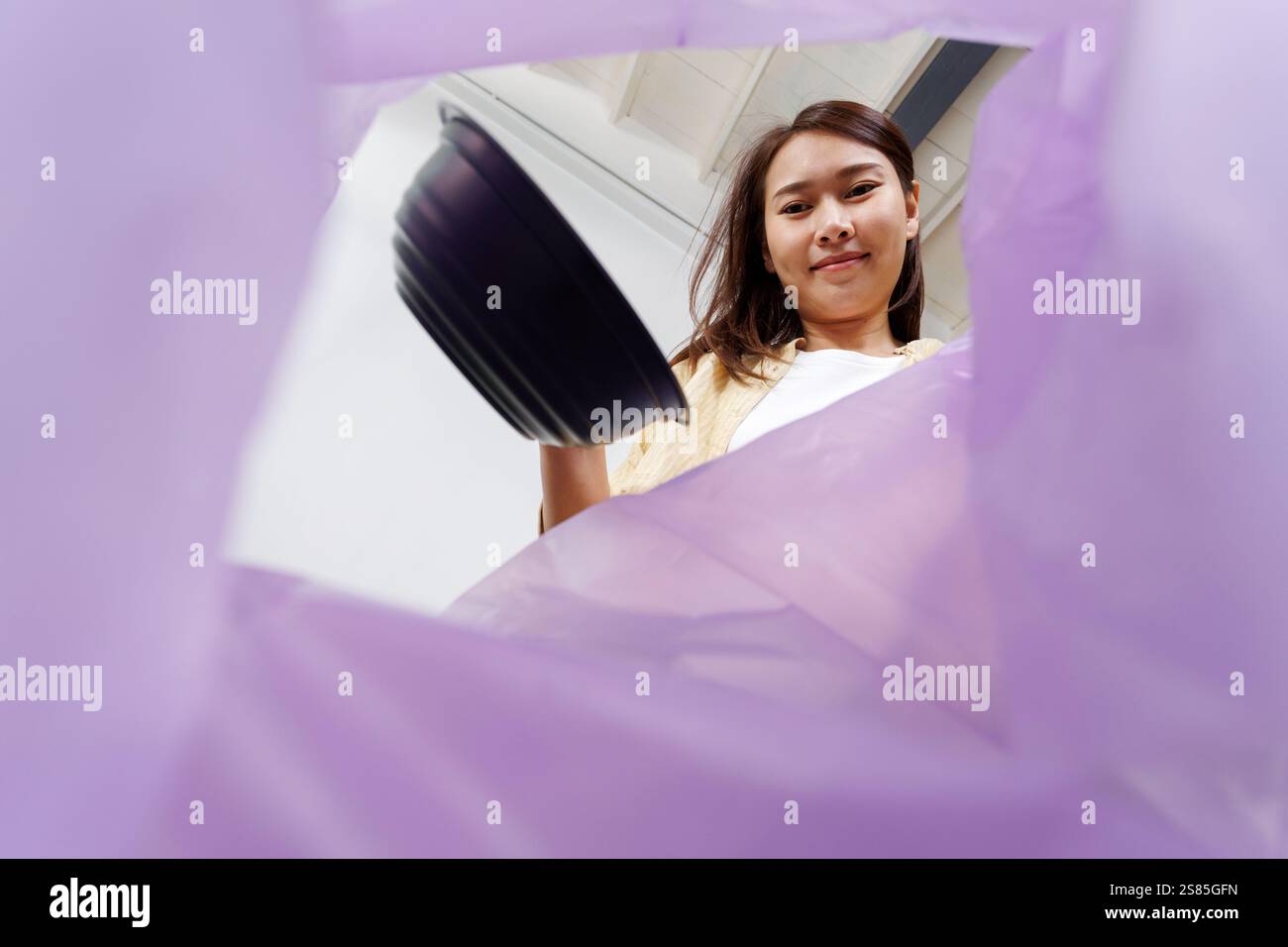 asian woman putting and sorting plastic food bowl waste to recycle bin ...