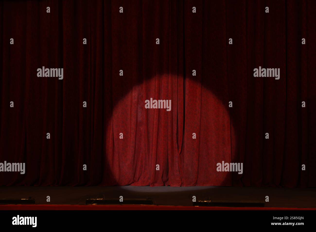 Elegant closed red curtains illuminated by spotlight in theatre Stock ...