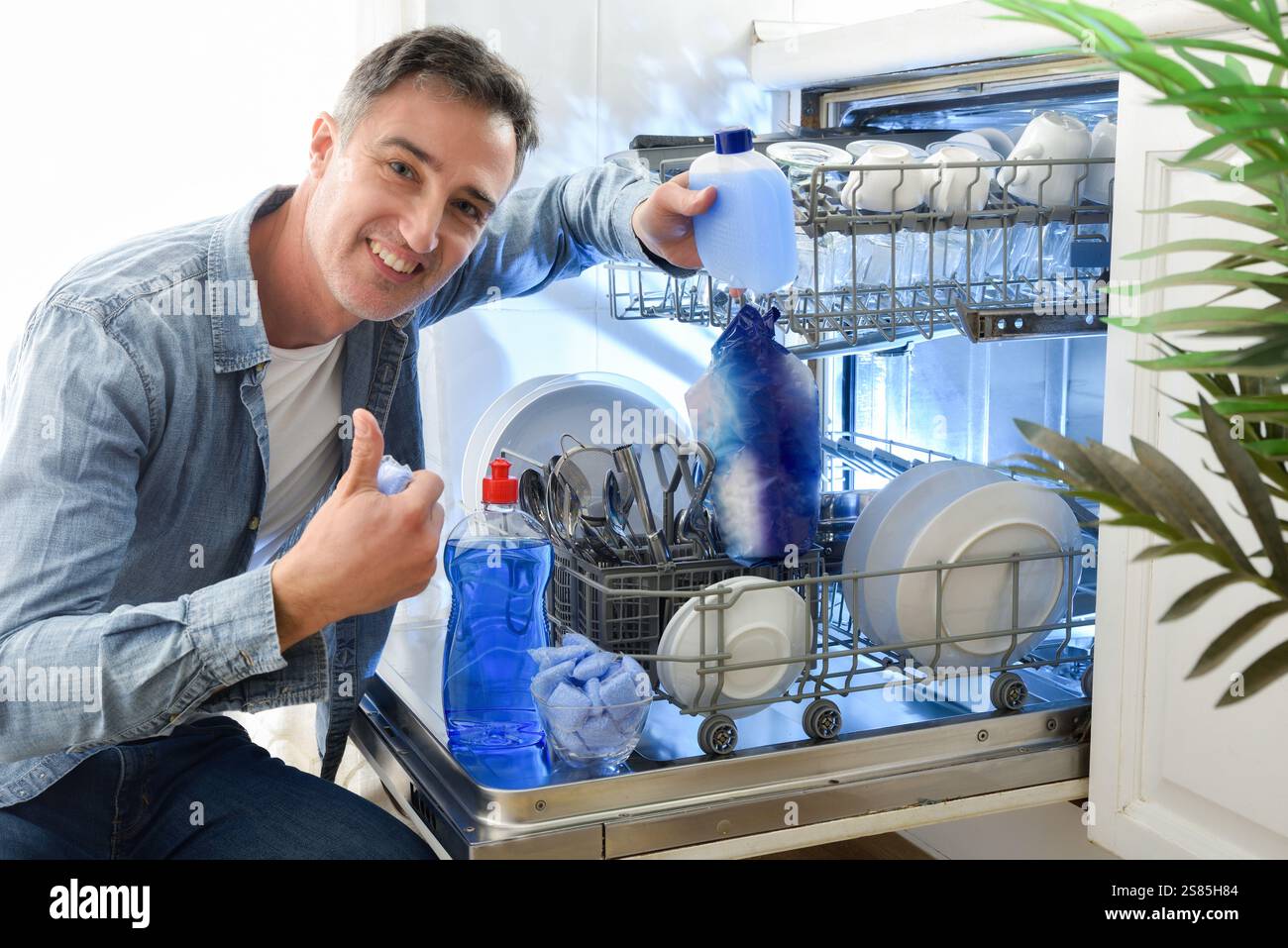 Smiling person showing dishwasher cleaning products next to a ...