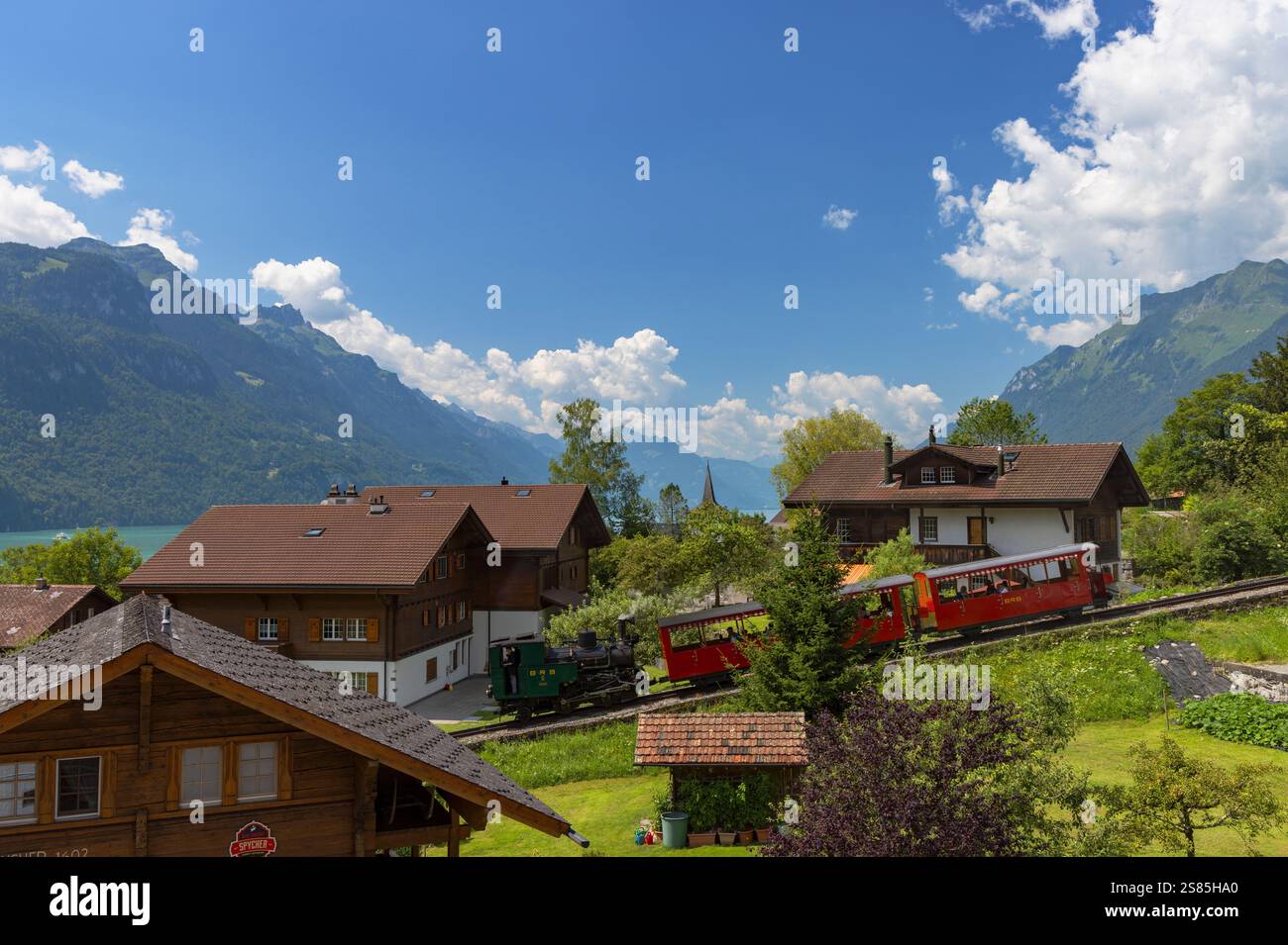 Brienz Rothorn train passing traditional chalets, Brienz, Bernese ...