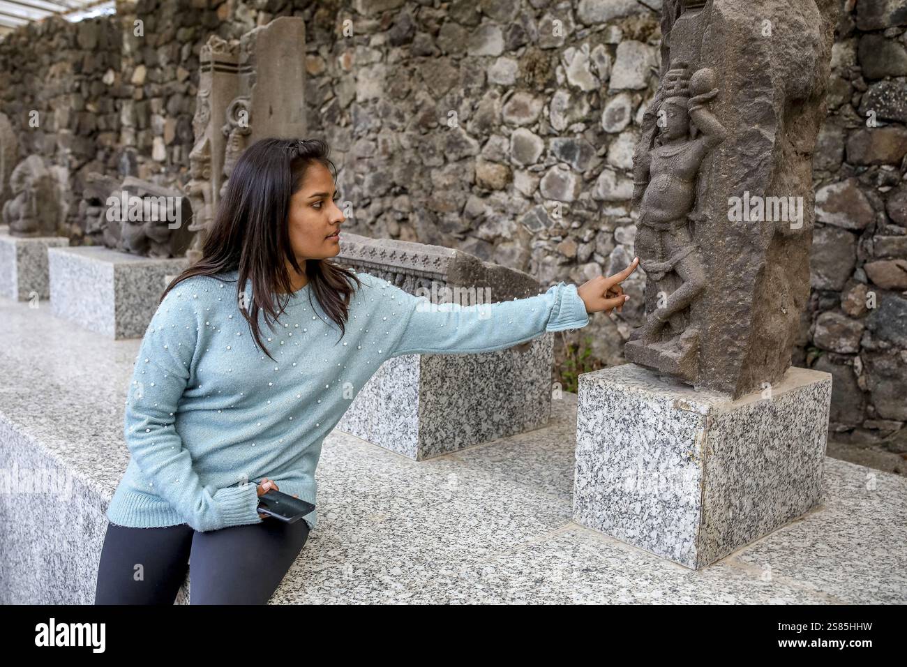 Student touching a statue in Daulatabad fort, Maharashtra, India Stock ...