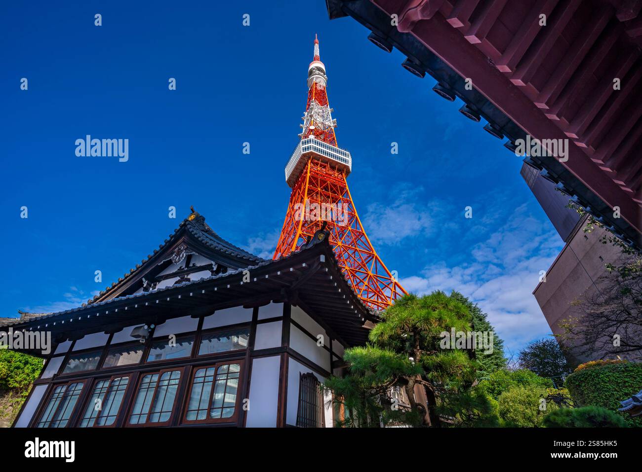 View of Tokyo Tower and Shinkoin Buddhist Temple against blue sky ...