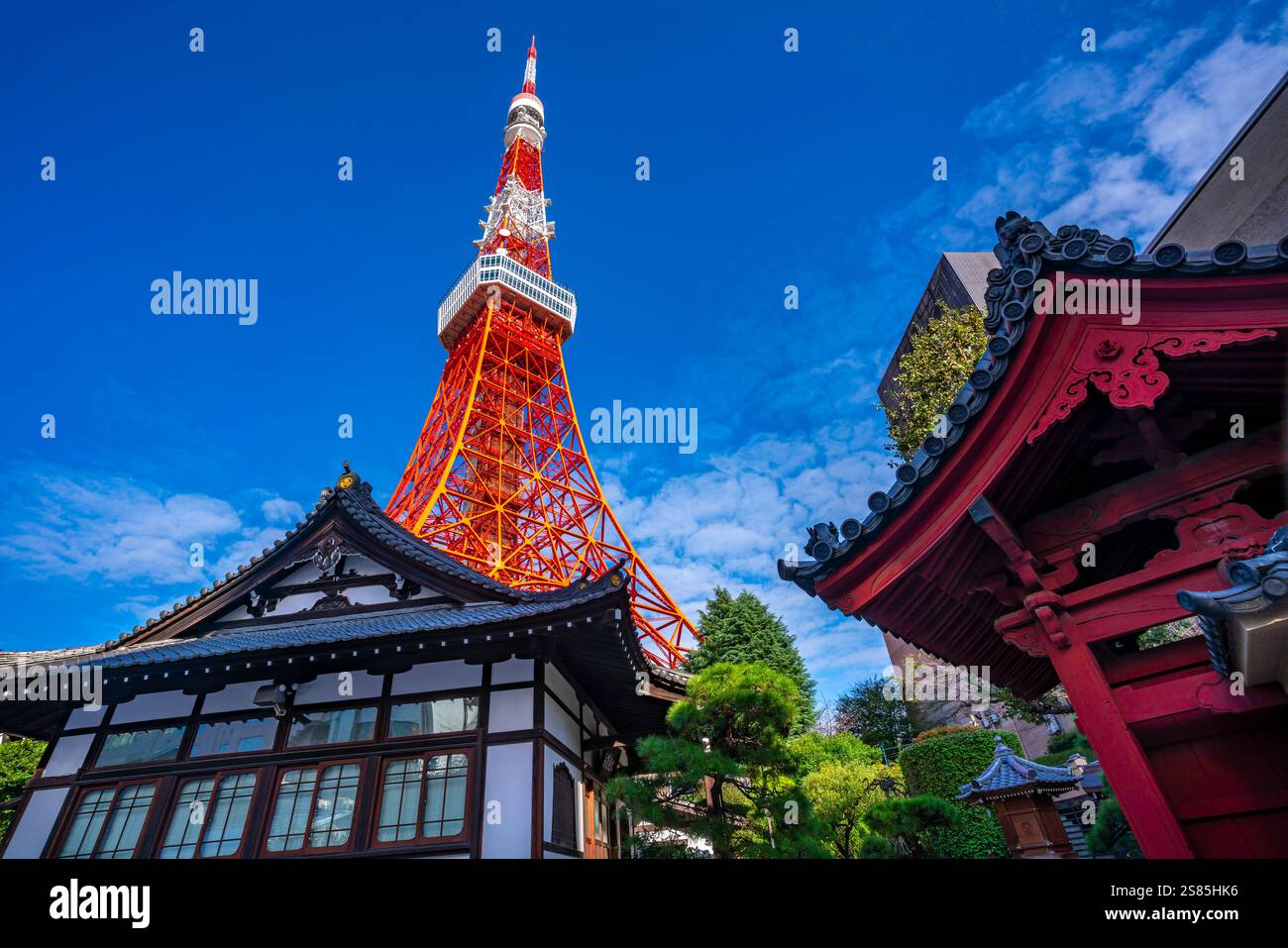 View of Tokyo Tower and Shinkoin Buddhist Temple against blue sky ...