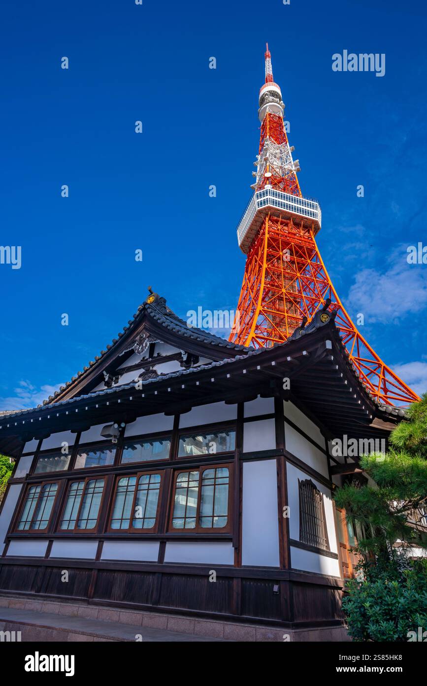 View of Tokyo Tower and Shinkoin Buddhist Temple against blue sky ...