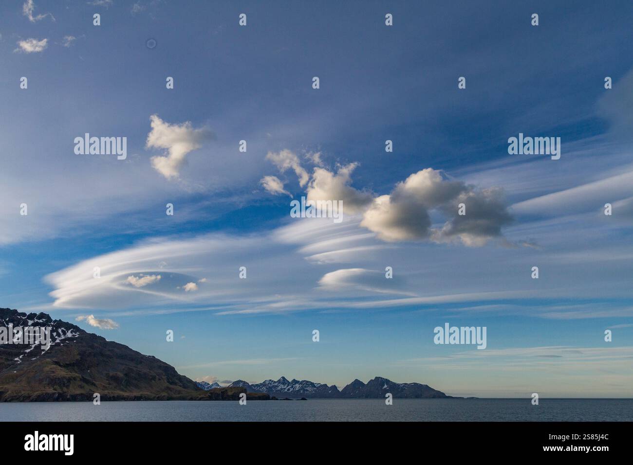 Interesting lenticular cloud formations forming over the island of ...