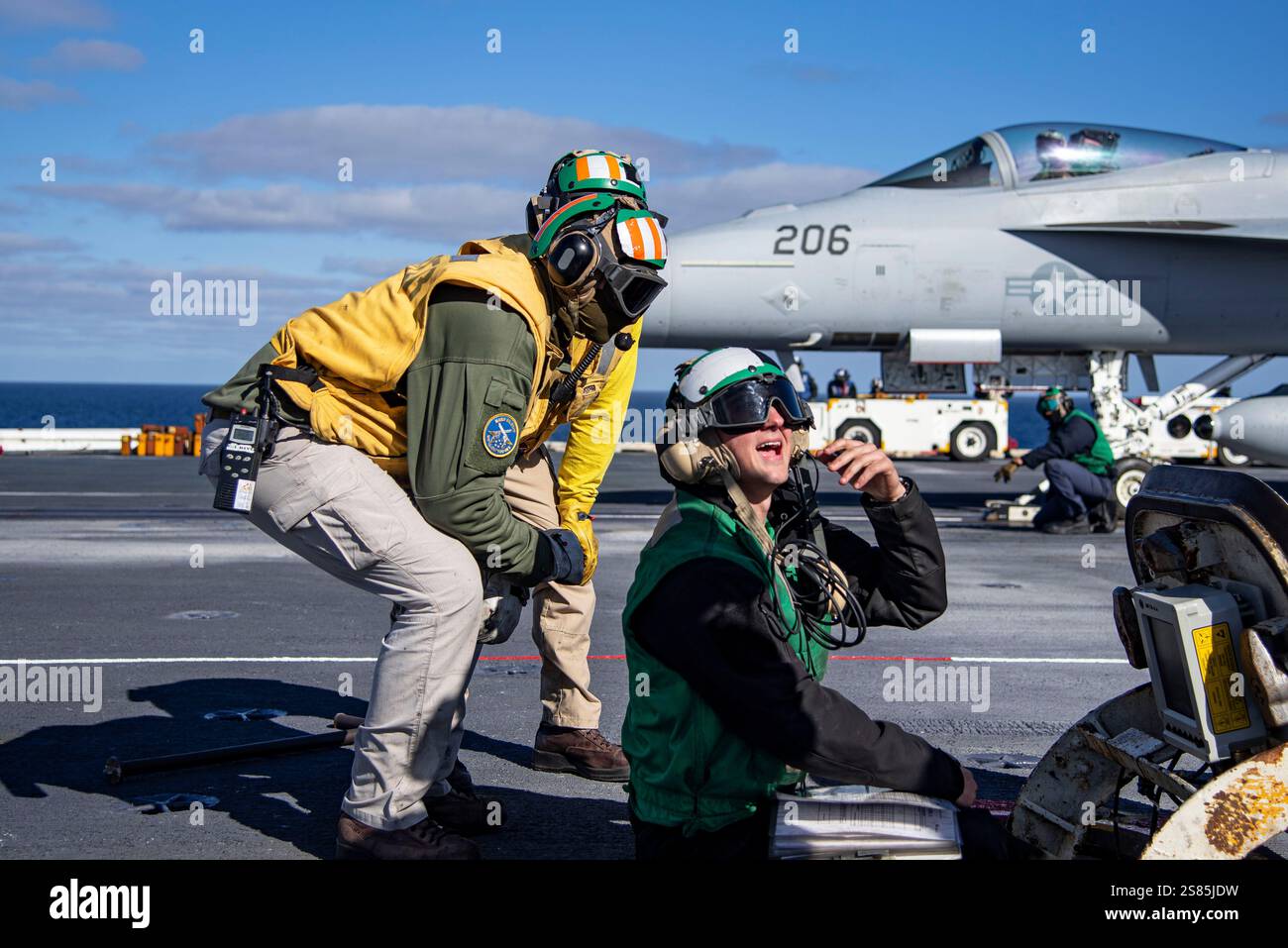 Sailors discuss safety precautions prior to launching aircraft on the ...