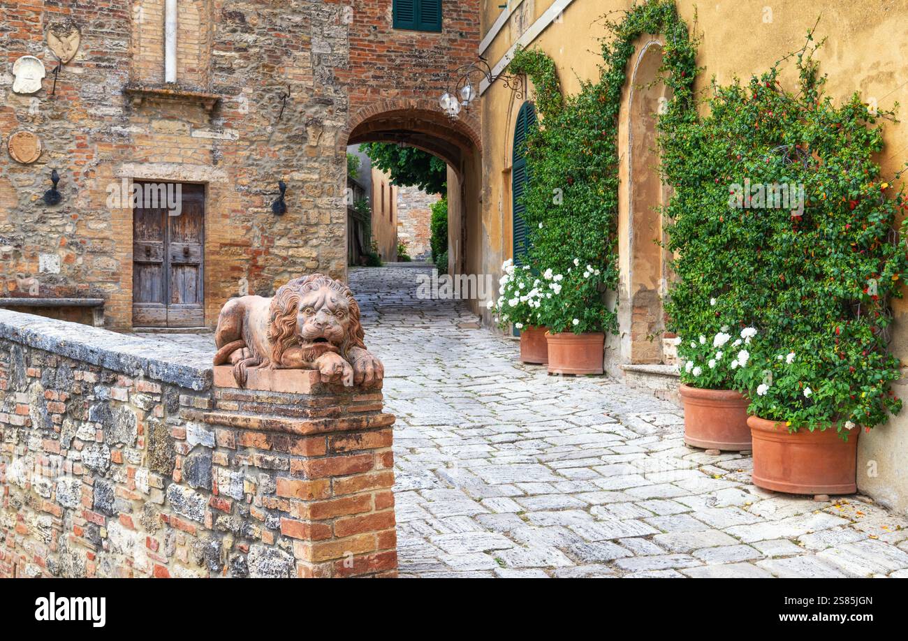 A stone lion guarding medieval village of Lucignano d'Asso, comune of ...