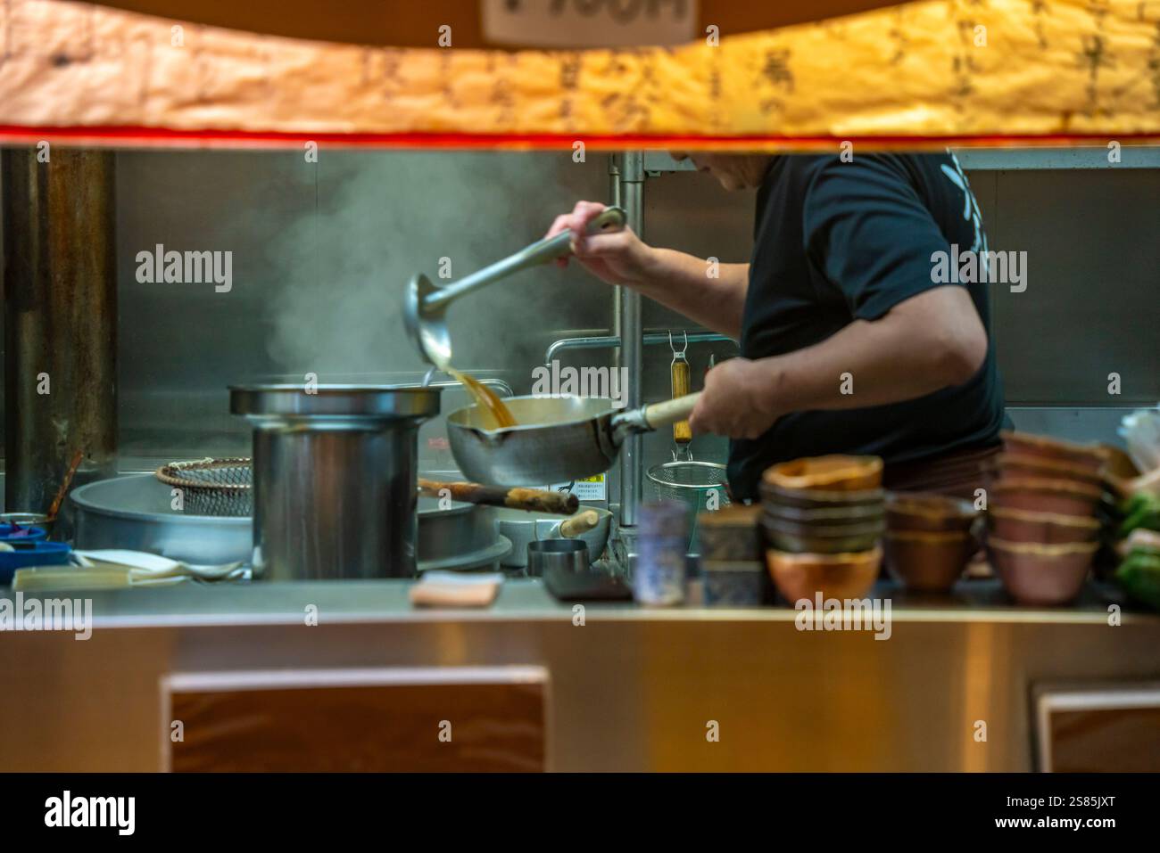 View of chefs busy at work through restaurant window in Omicho Market ...