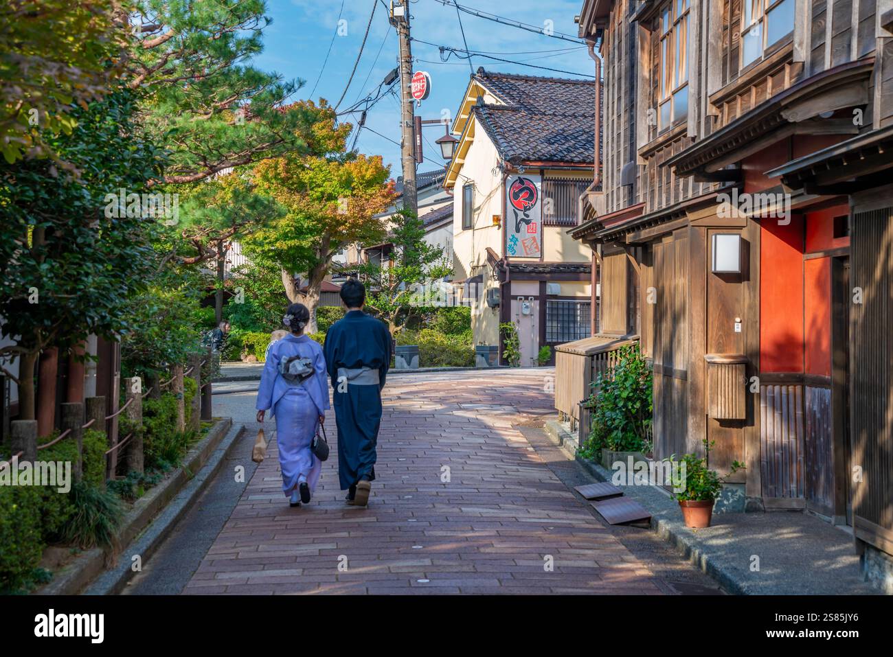 Local couple in kimono dress and traditional dark wood buildings in the ...