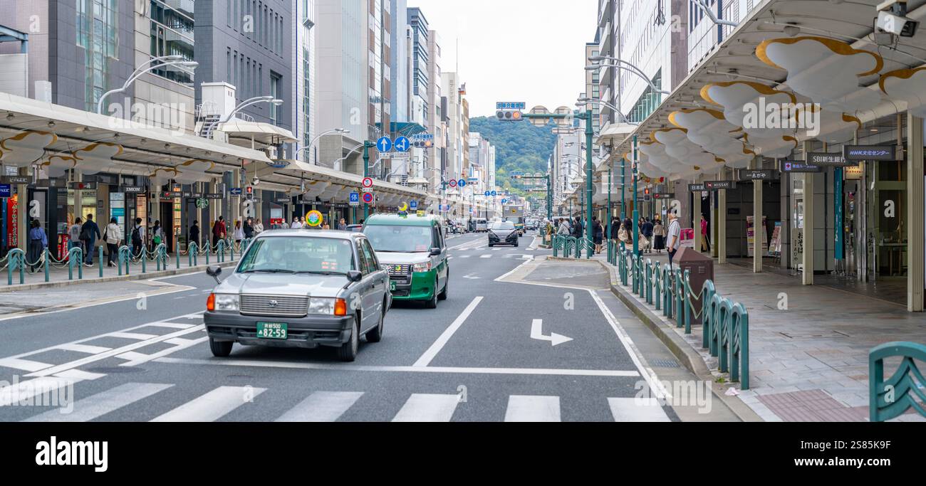 View of shops and cars on major streetin Kyoto, Shimogyo Ward ...