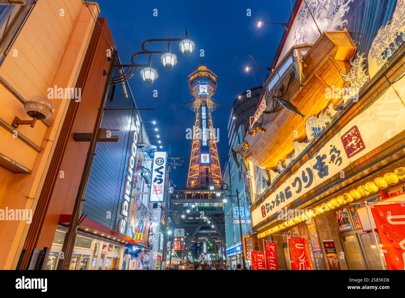 View of Tsutenkaku Tower and restaurants neon lights at dusk in the ...