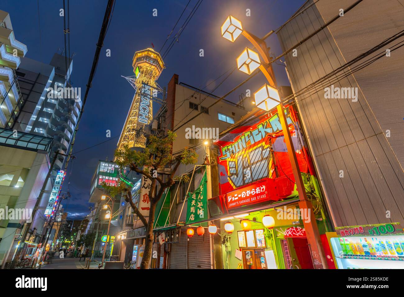 View of Tsutenkaku Tower and restaurants neon lights at dusk in the ...