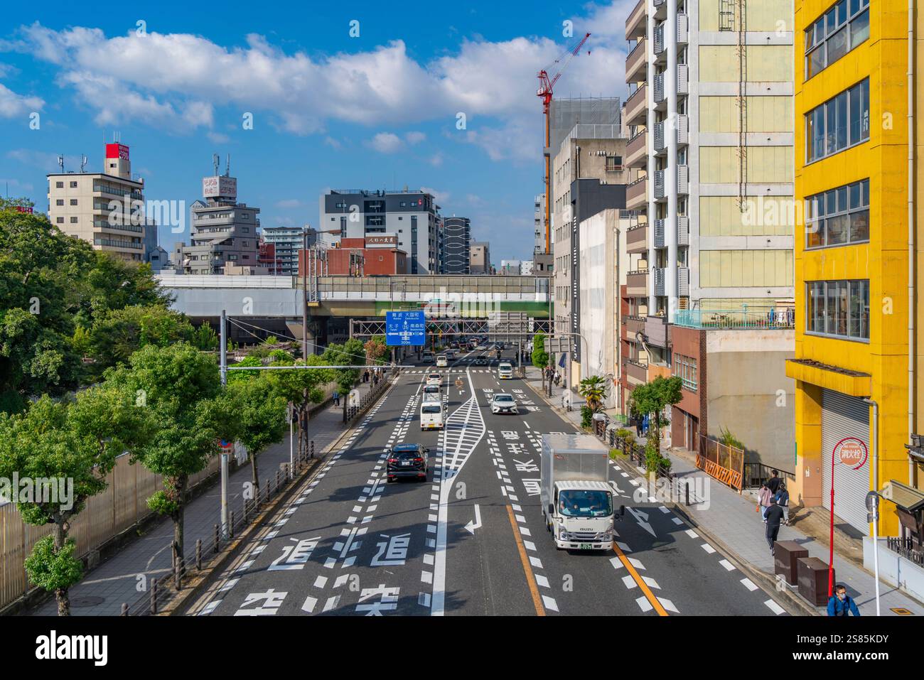 View of busy road and city skyline on a sunny day in the Shinsekai area ...