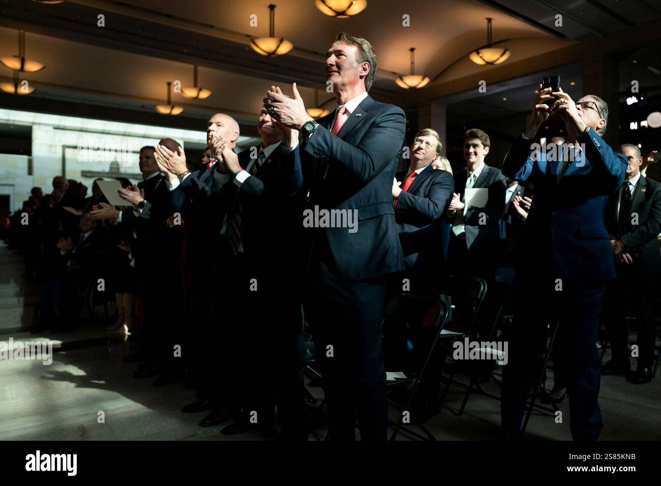 Virginia Governor Glen Youngkin (R) is seen in an overflow room in ...