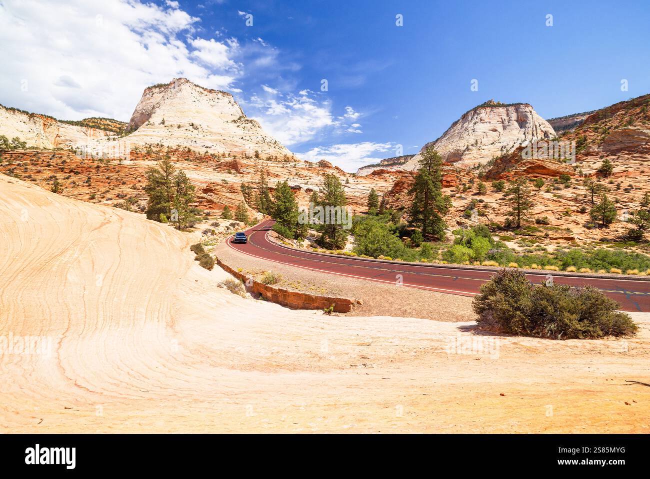 Car driving along scenic road in Zion National Park on a sunny summer ...