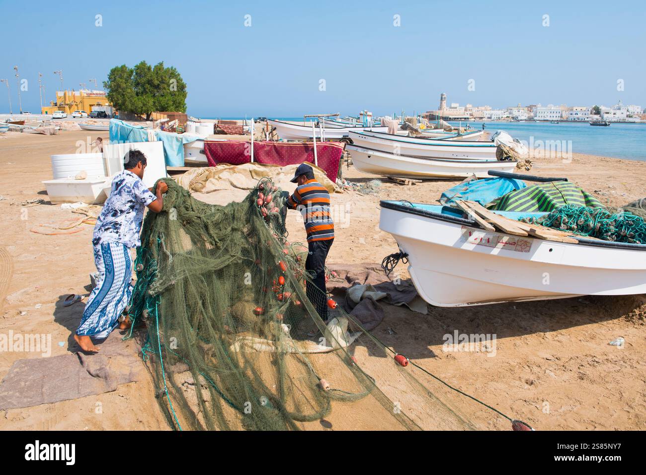 Fishermen on the beach in front of the Al Ayjah village, Sur, port-city ...