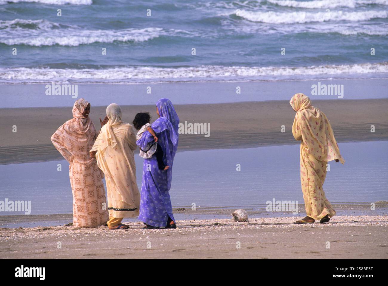 Women dressed in saris on the beach of Barka, Sultanate of Oman ...